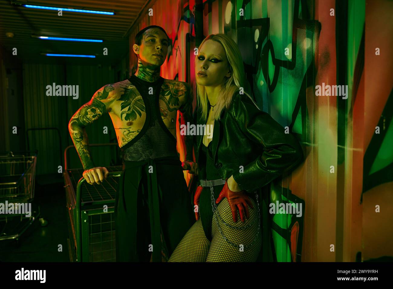 A man and a woman standing side by side at a lively rave party Stock ...