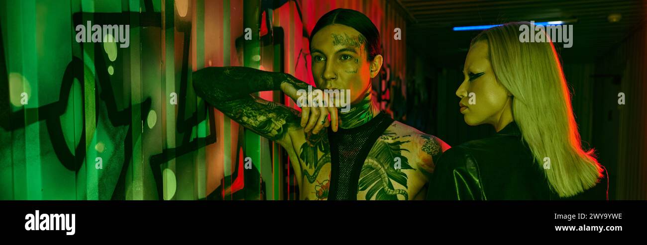 A man and a woman stand side by side at a lively rave party Stock Photo ...