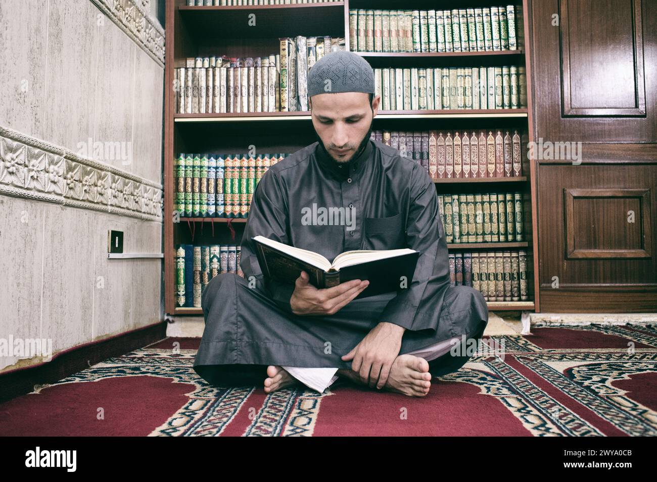 Palestinian in a mosque studying the holy Coran in Sabra-Shatila ...