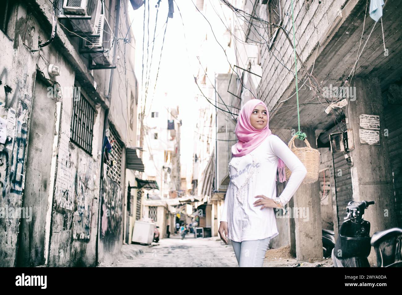A young Palestinian girl posing for a photo in the chaotic streets of ...