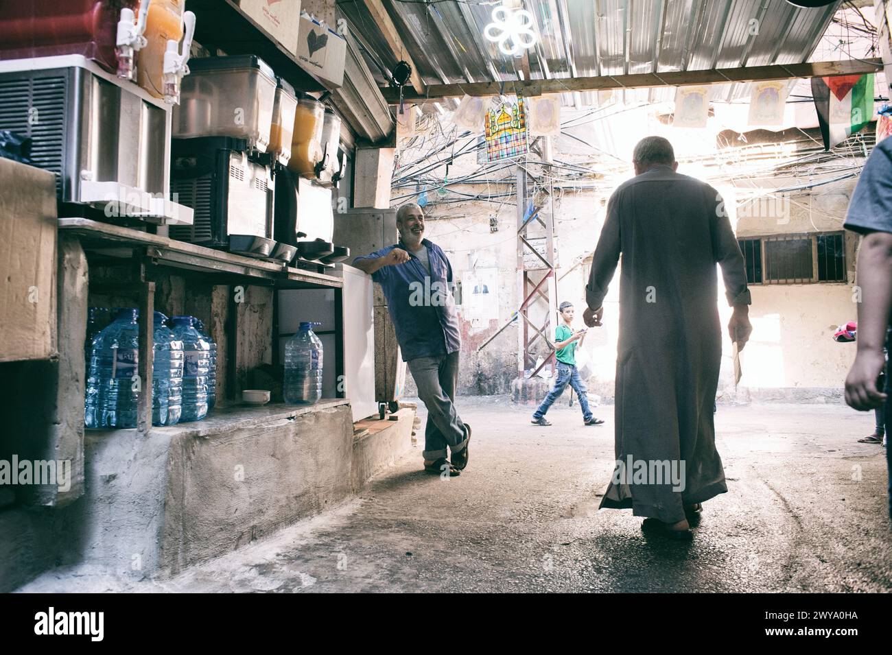 Photograph of the dynamic street life of Sabra-Shatila Refugee Camp in ...