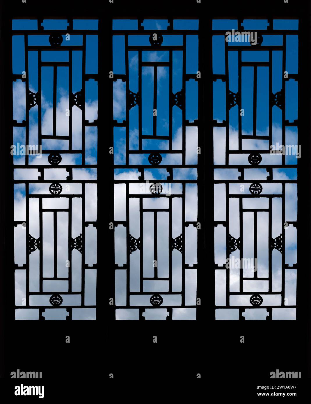 View through a fretwork screen panel of a blue sky and clouds Stock ...