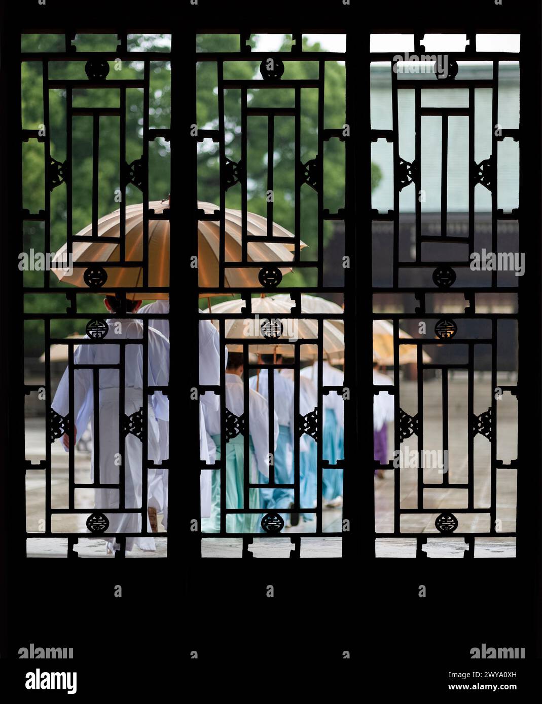 View through a fretwork screen panel of ceremony at Meji Shrine, Tokyo ...