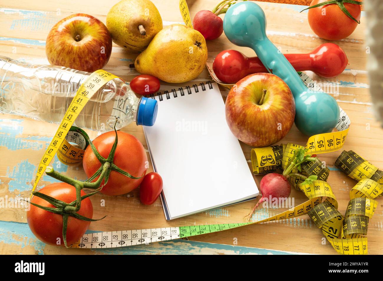 paper notepad with fruits and gym equipment associated with diet and ...