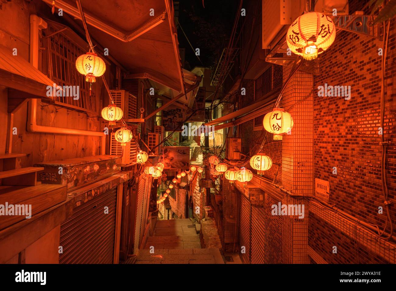 An alley exudes charm with a series of red lanterns guiding the way up ...