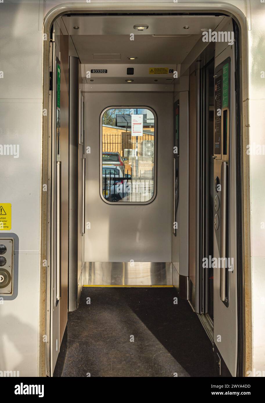 The internal corridor of a railway train carriage from an open door. A ...