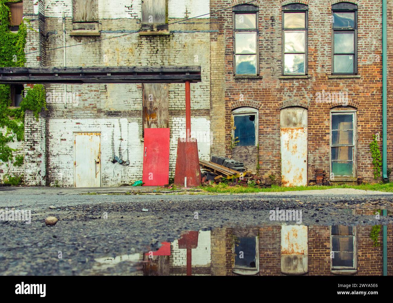 A desolate rural American scene with aged brick buildings and boarded ...