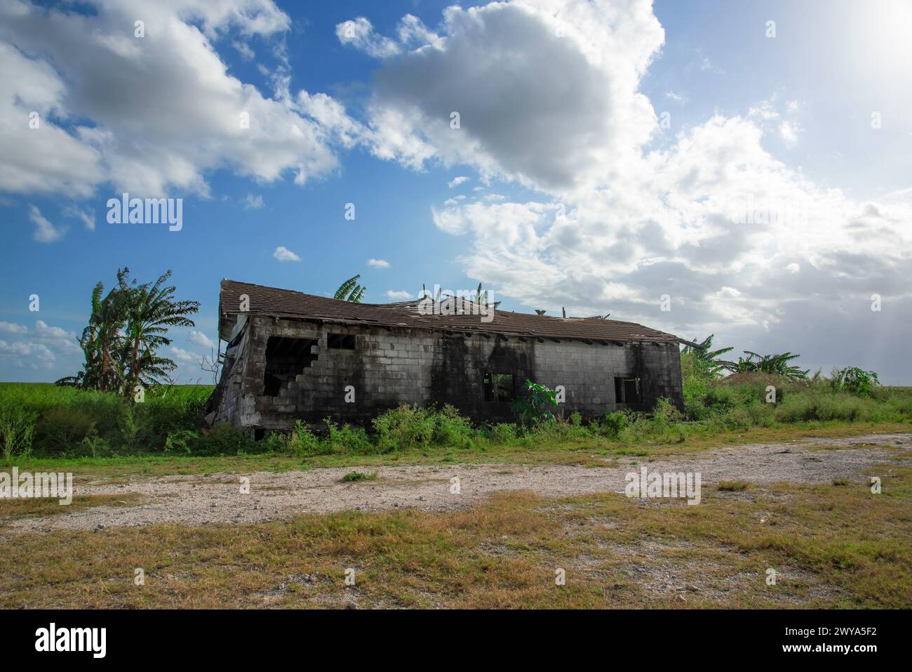 An abandoned decrepit stone block building isolated in the middle of ...