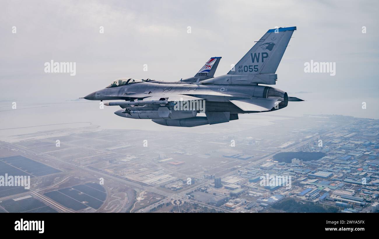 Two F-16 Fighting Falcons from the 35th Fighter Squadron, fly over the ...