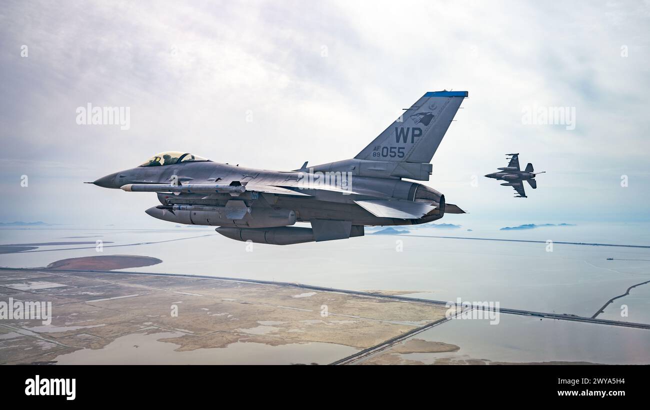 Two F-16 Fighting Falcons from the 35th Fighter Squadron, fly over the ...