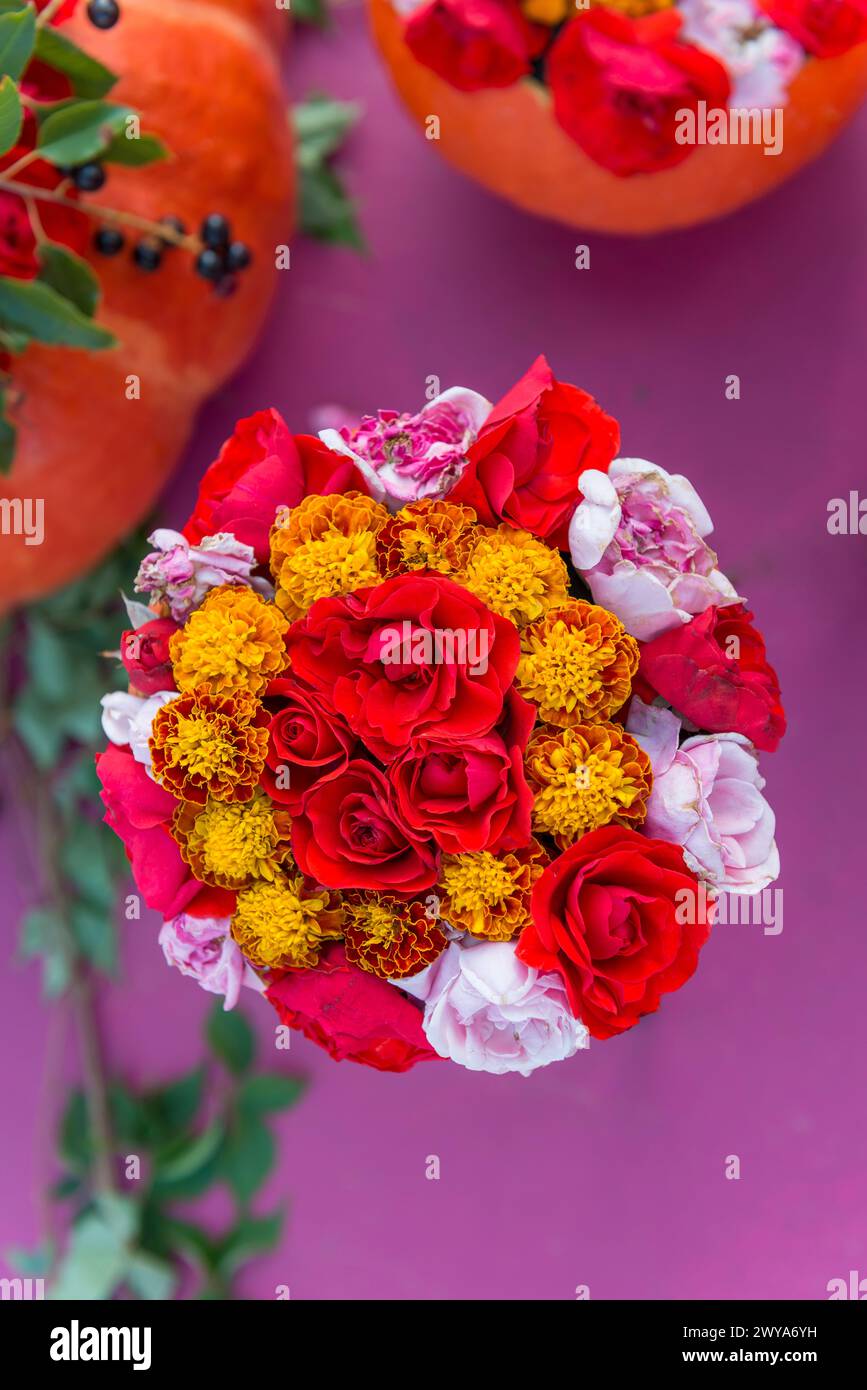 A beautiful floral arrangement featuring a mix of roses and assorted ...