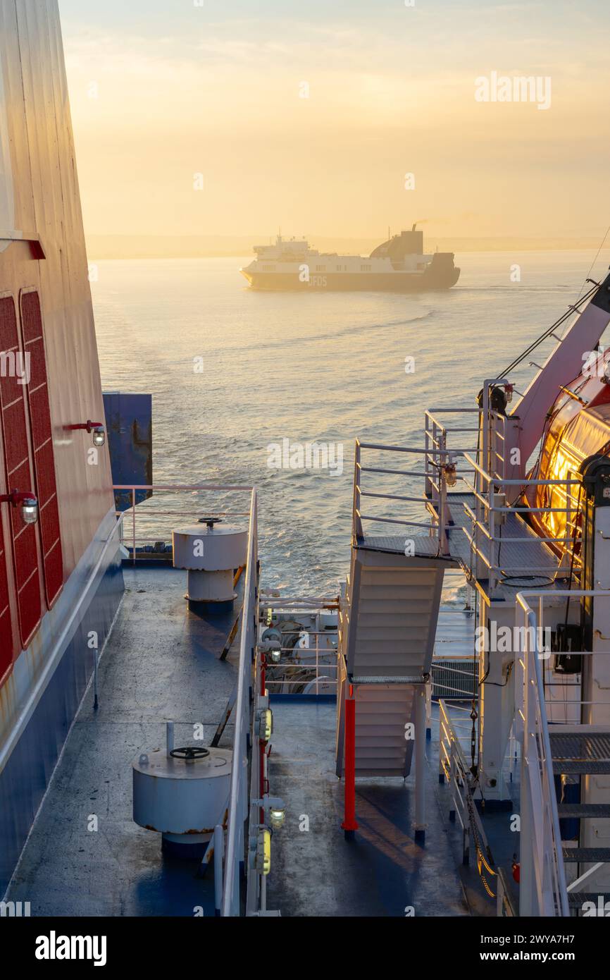 Car ferry (DFDS) on the Irish sea, approaching Rosslare, at dusk, as ...