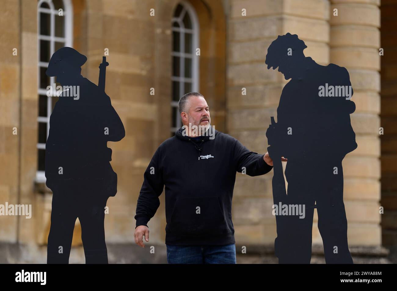 Artist Dan Barton stands beside some of the giant silhouettes from the ...