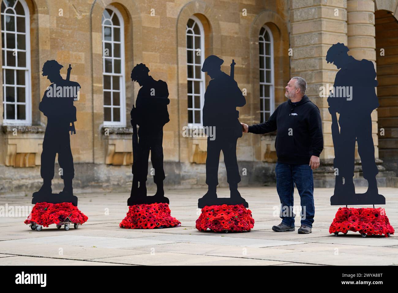 Artist Dan Barton stands beside some of the giant silhouettes from the ...