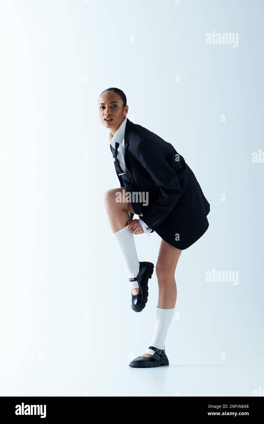 emotional african american woman pulling her sock while posing in ...