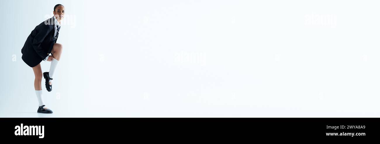 emotional african american woman pulling her sock while posing in ...