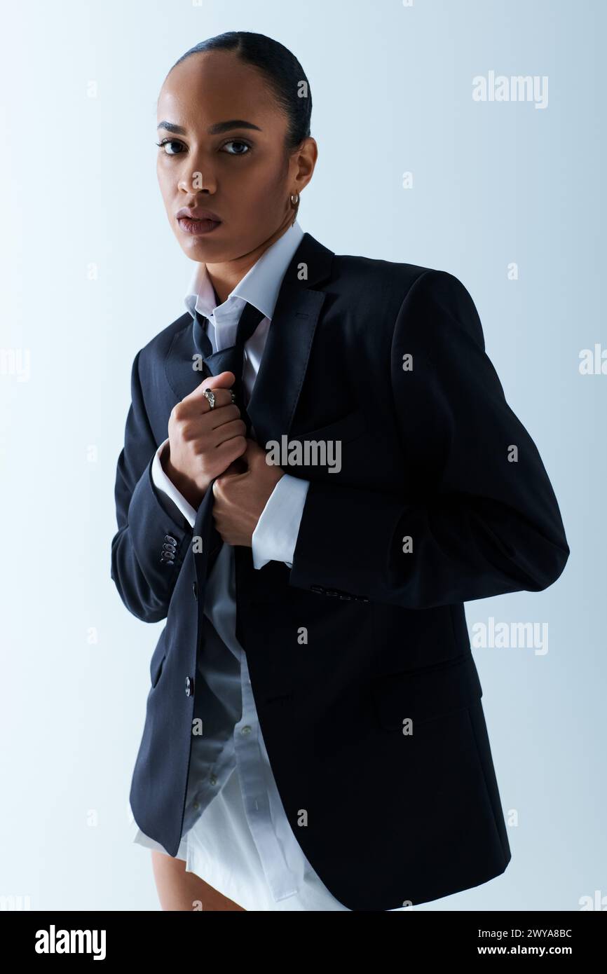 Young African American woman in her 20s wearing a suit and tie ...