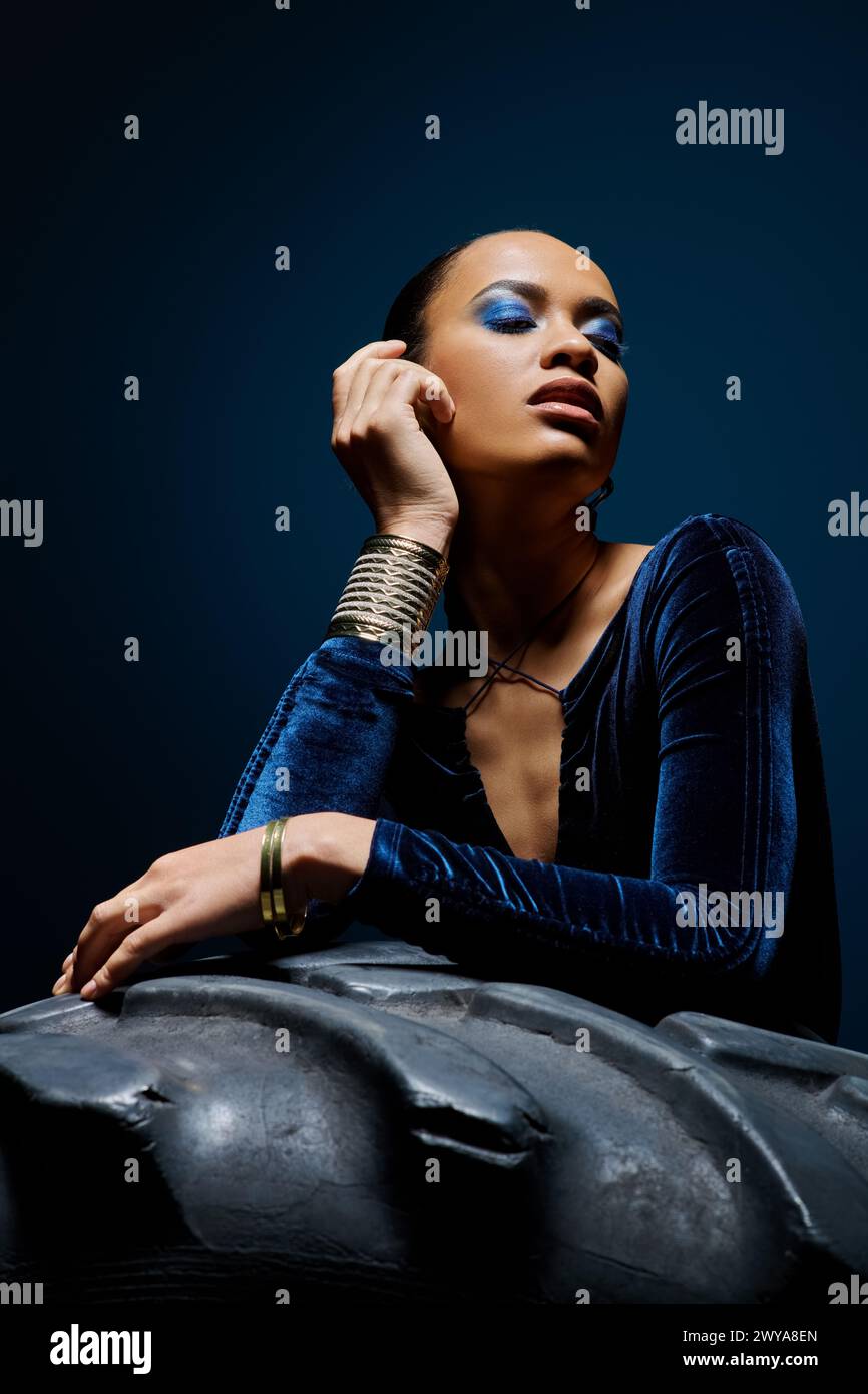 A young African American woman sits gracefully atop a mysterious black ...