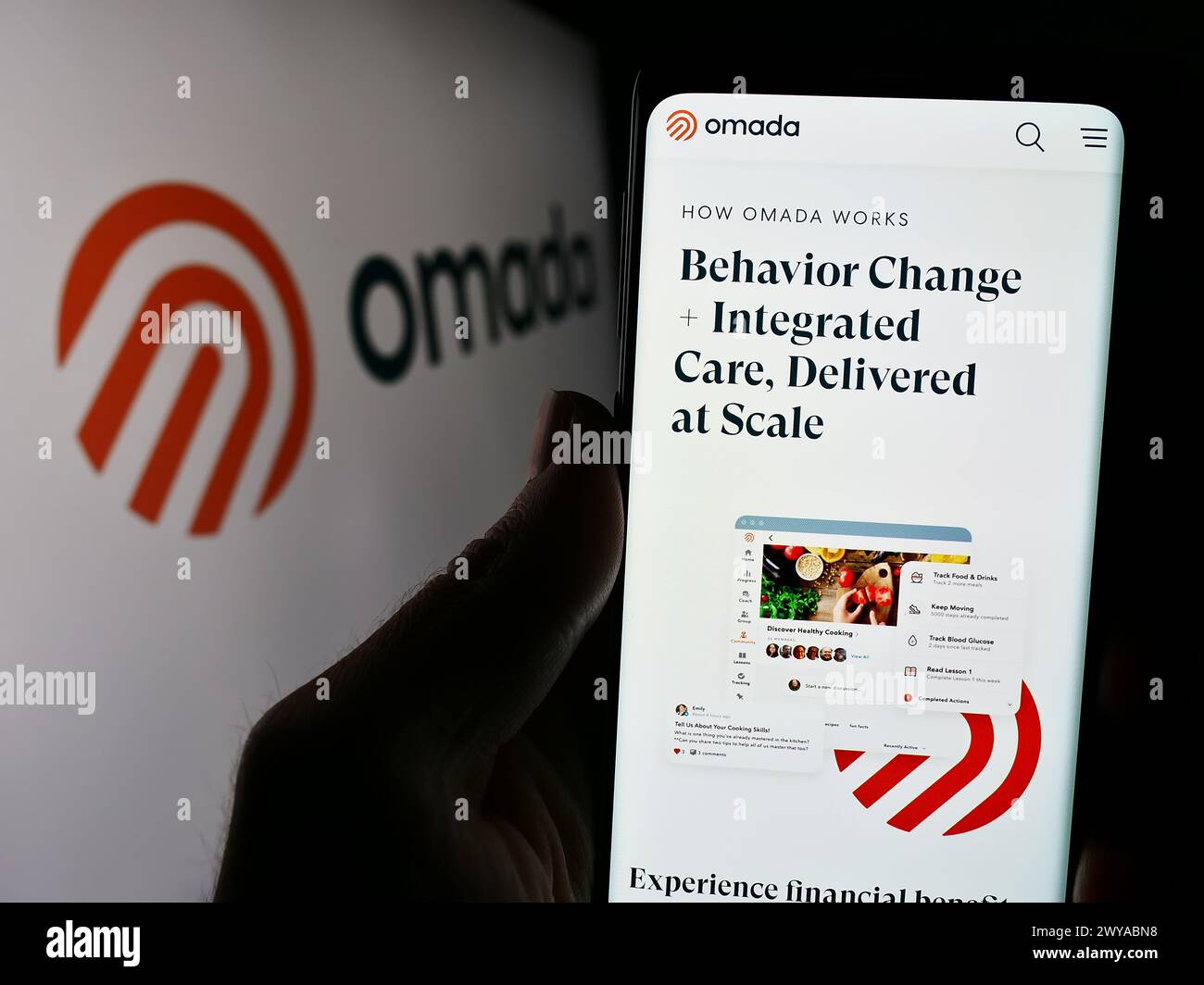 Person holding smartphone with webpage of US healthcare company Omada ...