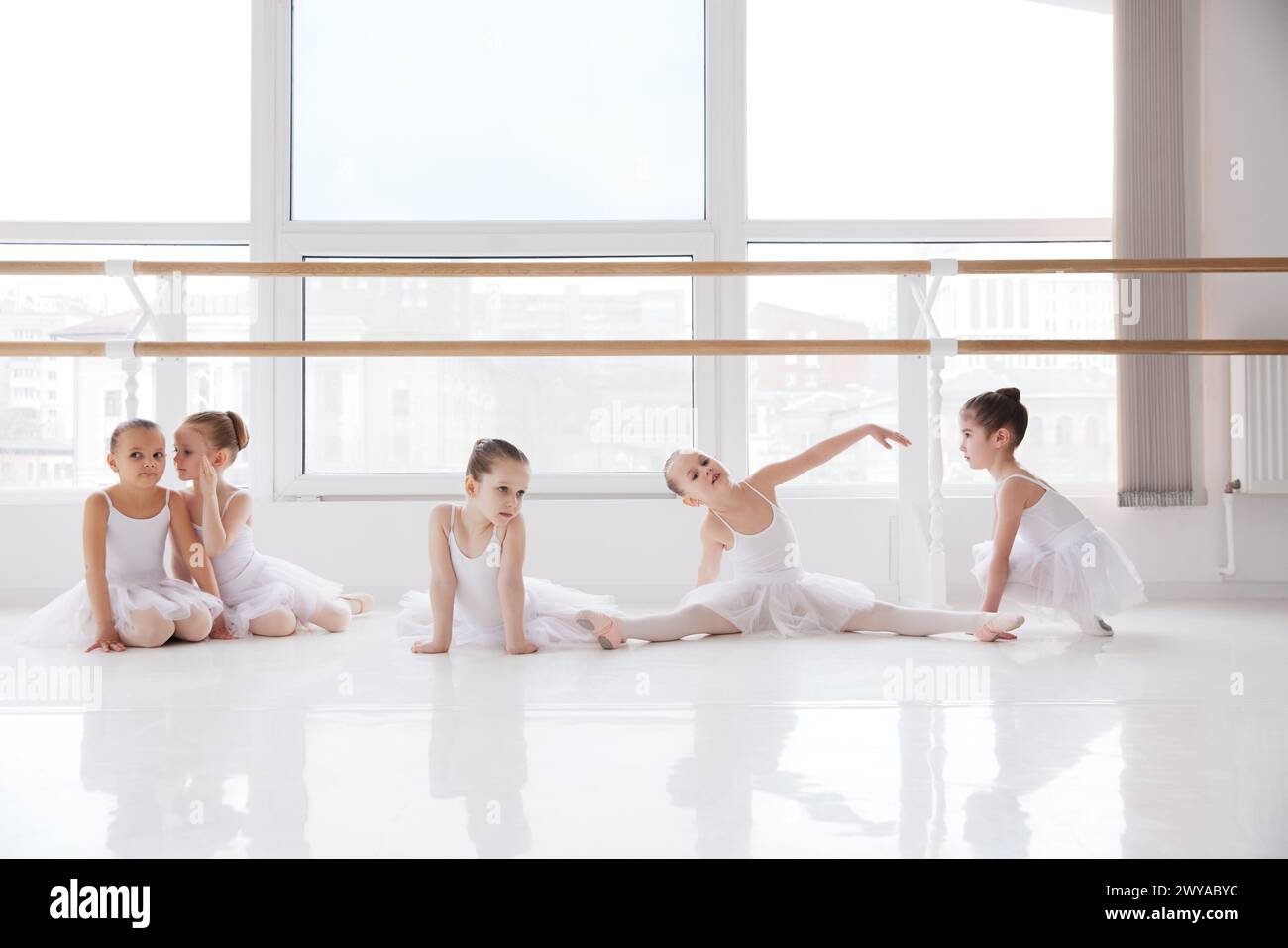 Children, little girls in ballet attire focusing on dance exercises at ...