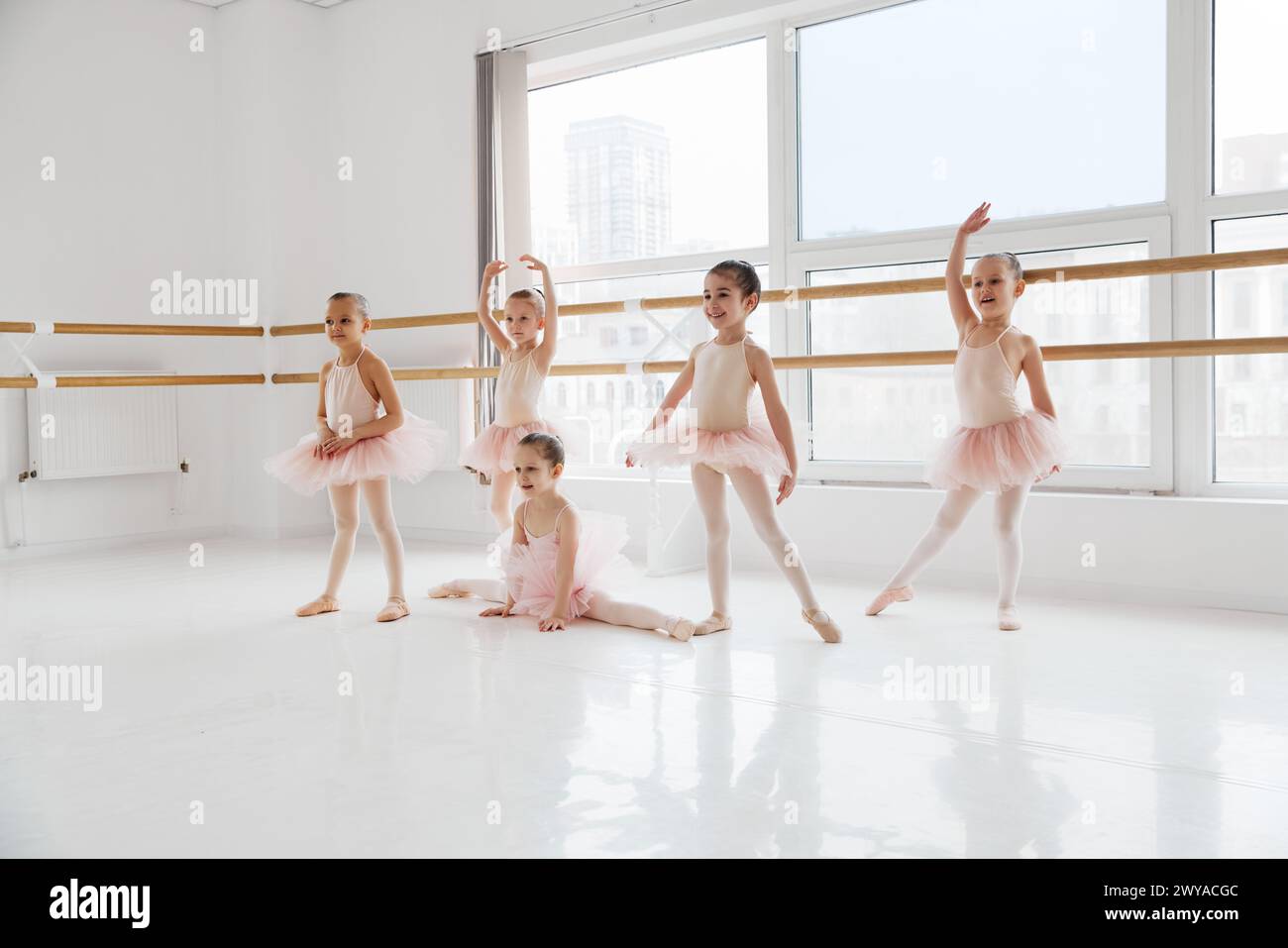 Group of little girls in ballet attire performing various dance ...