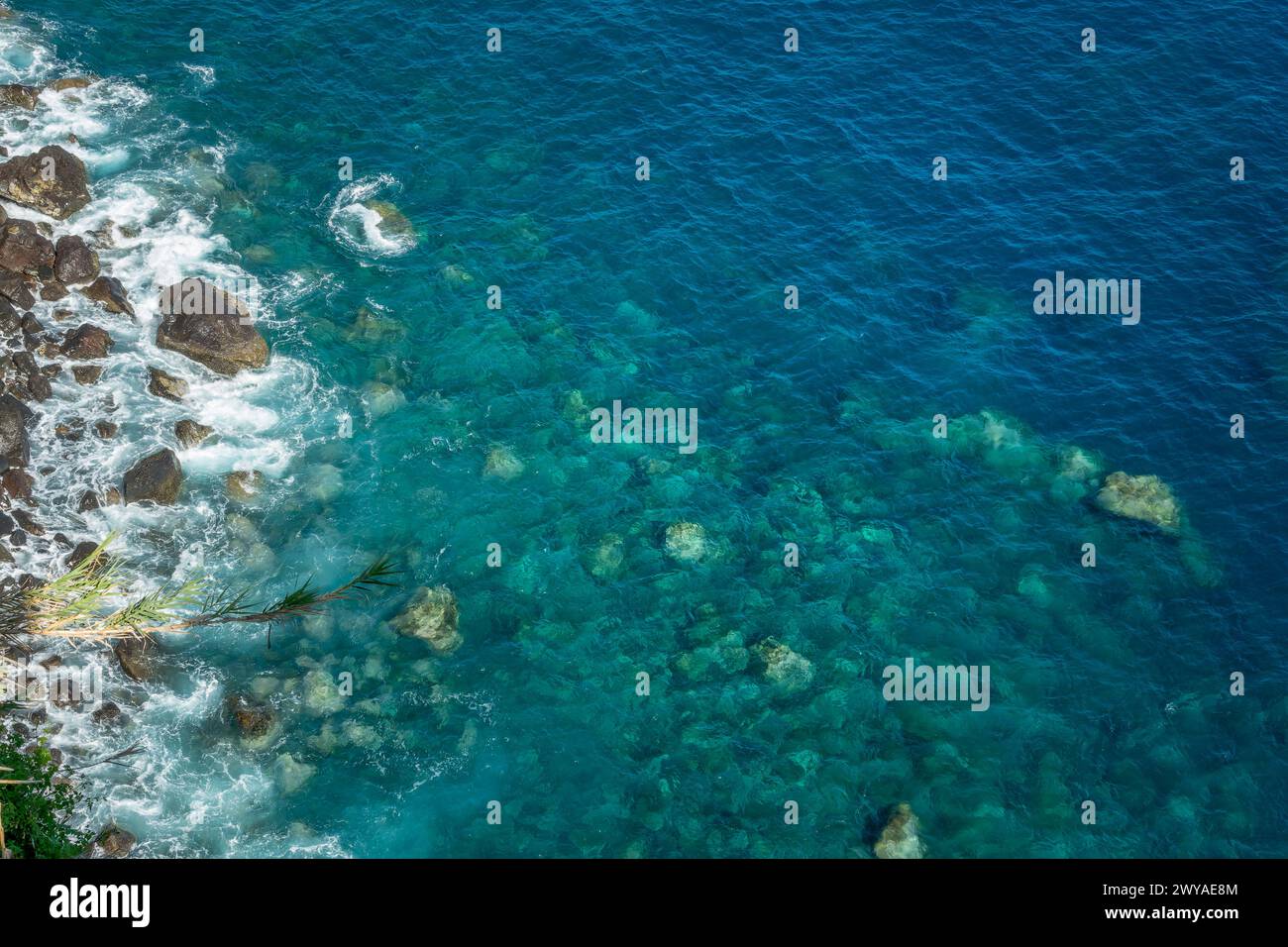Drone view of rocks and blue pristine sea with clear transparent water ...