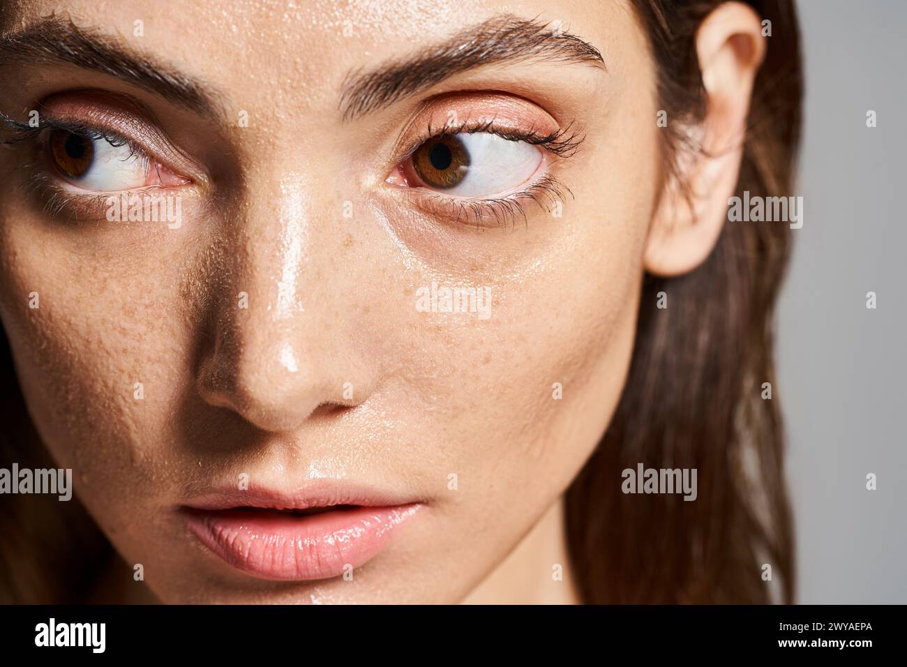 A close-up of a young Caucasian woman with mesmerizing brown eyes ...