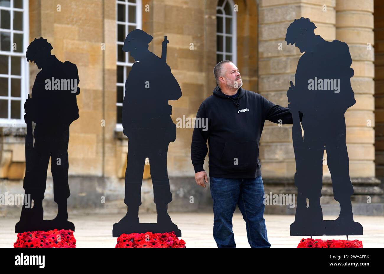 Artist Dan Barton stands beside some of the giant silhouettes from the ...