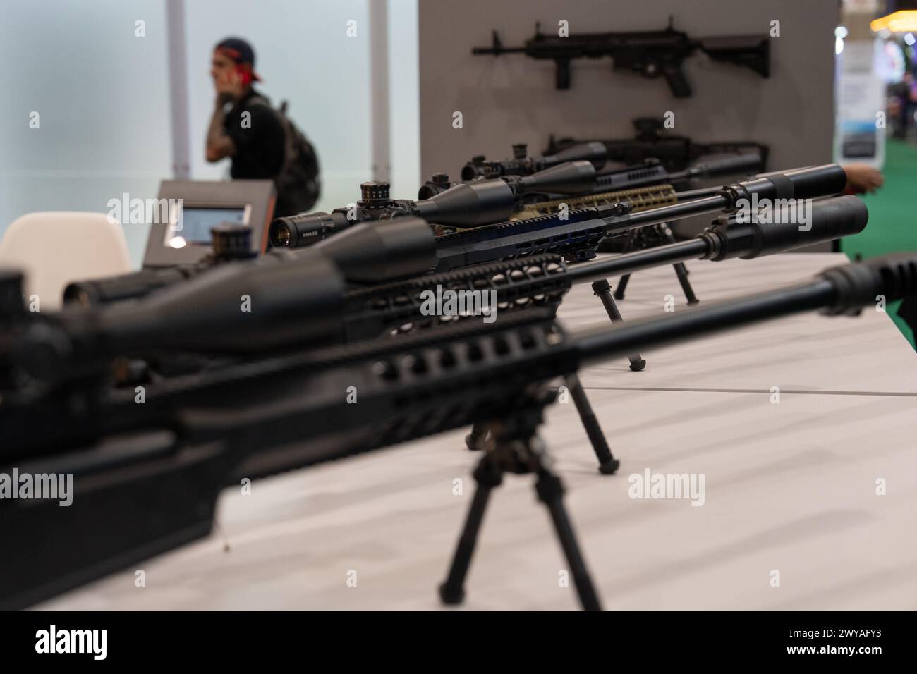 Sao Paulo, Brazil. 4th Apr, 2024. A man walks past a booth displaying ...