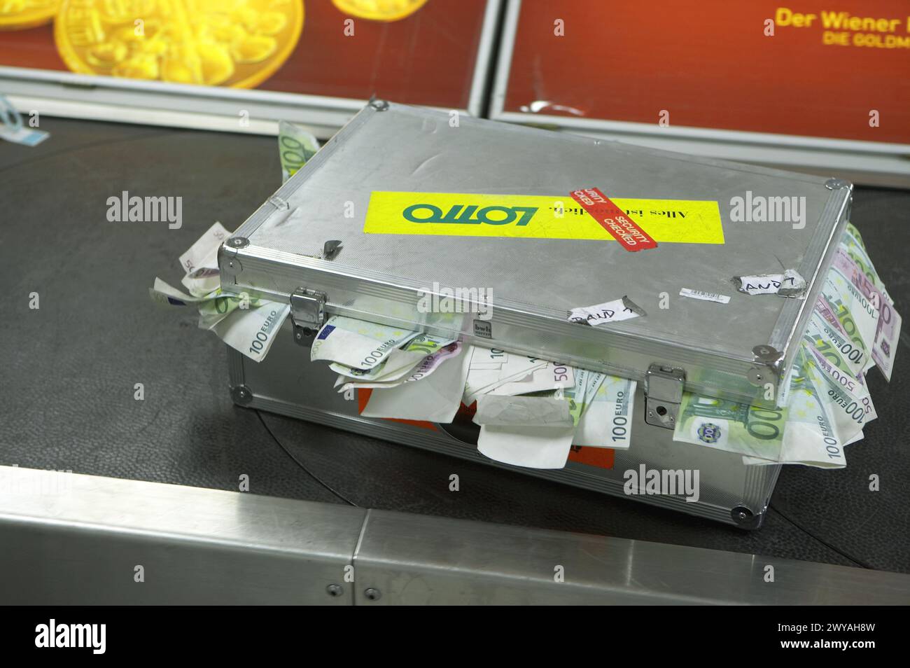 Suitcase full of money on airport baggage claim conveyer, advertising ...