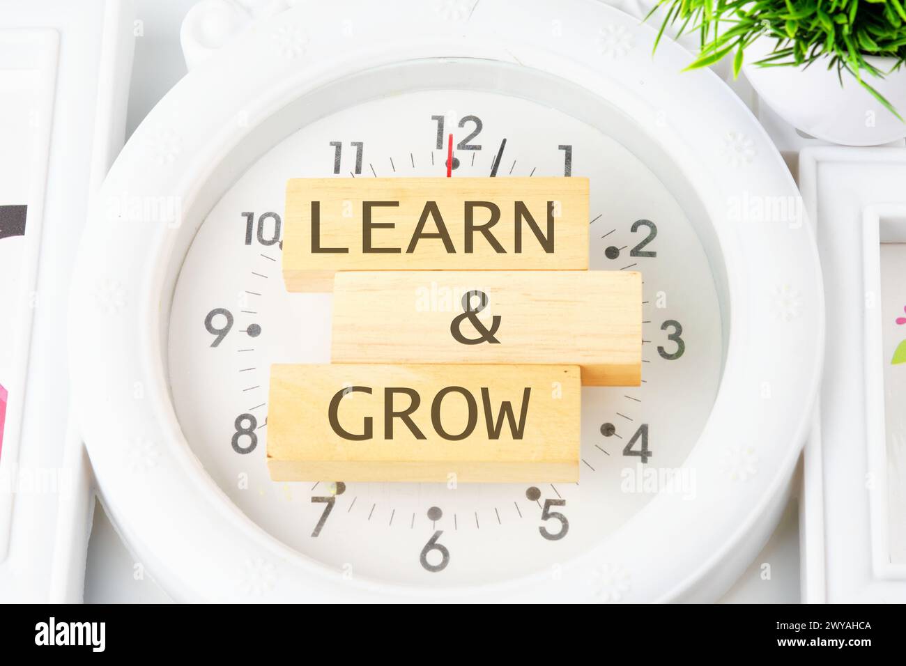 Learn and Grow written on the wooden blocks on the clock with hands ...