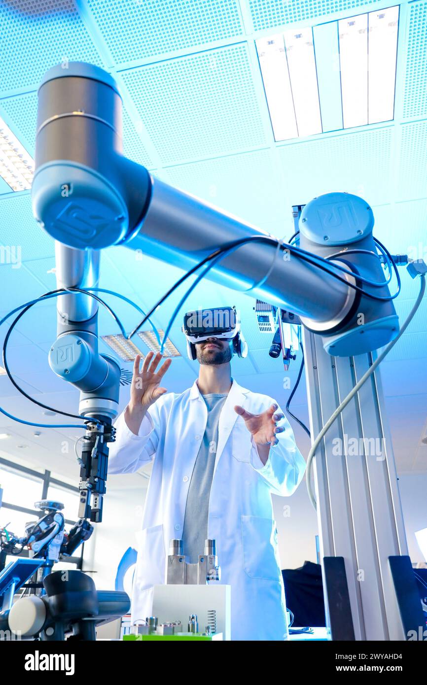 Robotic arm with artificial vision, Researcher with virtual reality glasses, VR, Humanoid robot ...