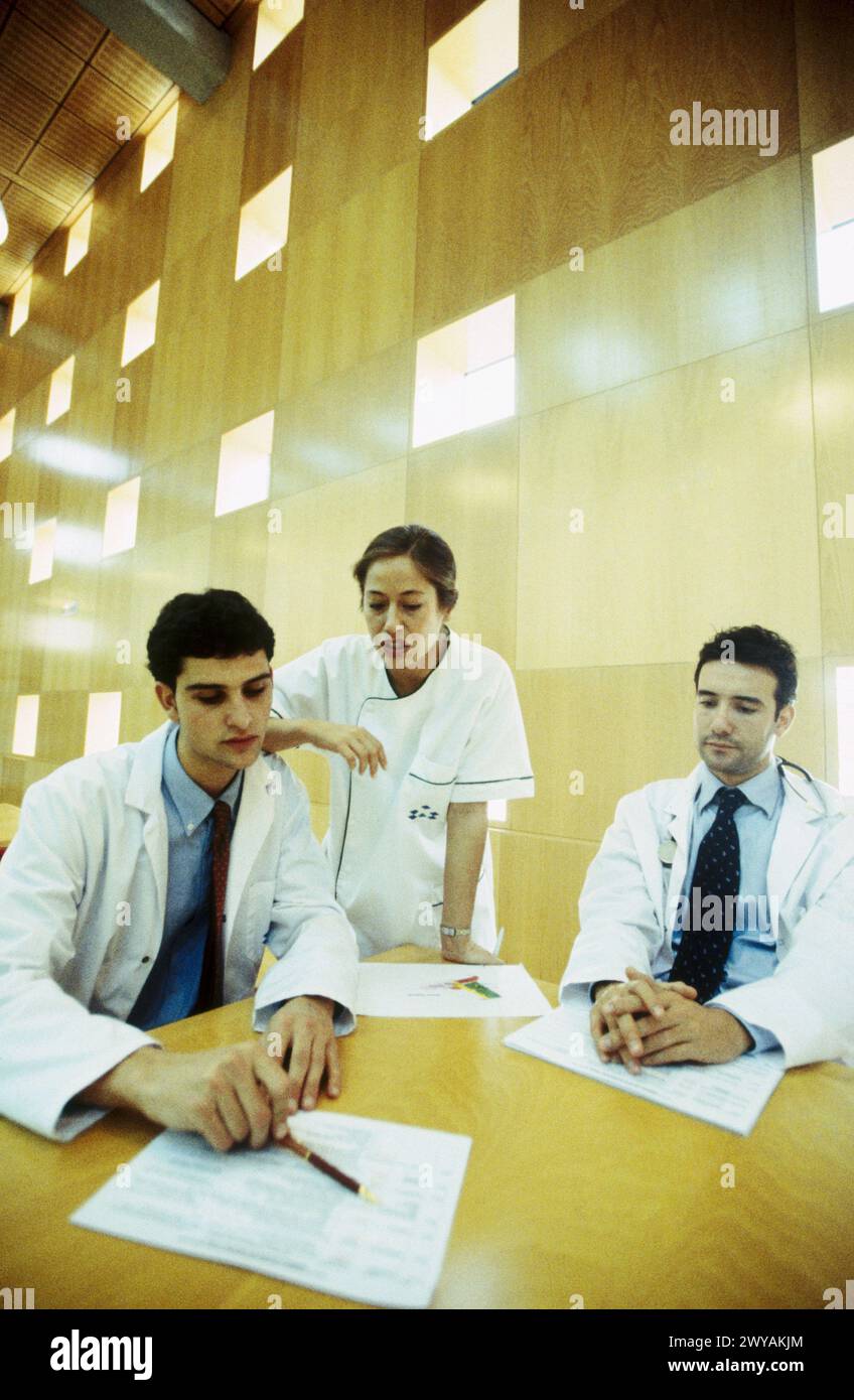 Meeting of doctors at library of hospital Stock Photo - Alamy