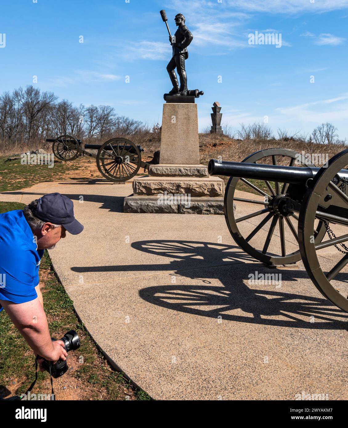 A man photographing monuments and cannons in the Gettysburg National ...