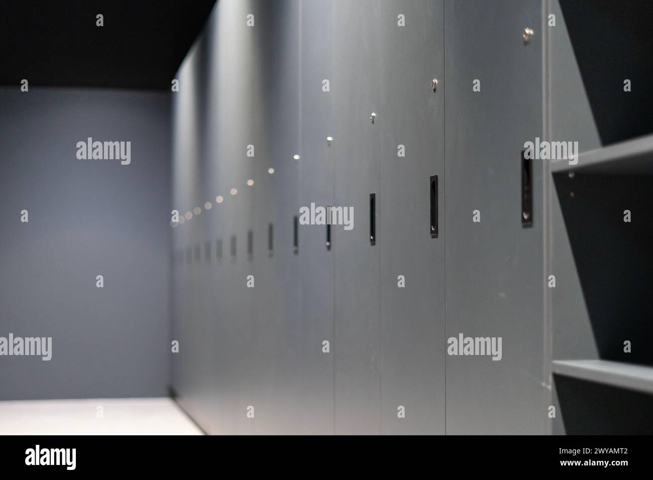 A row of closed gray cabinets in a corridor Stock Photo - Alamy