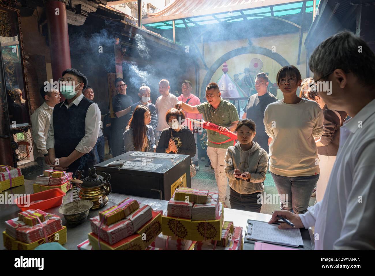 A Taoist shaman practicing a religious ceremony for one of his ...