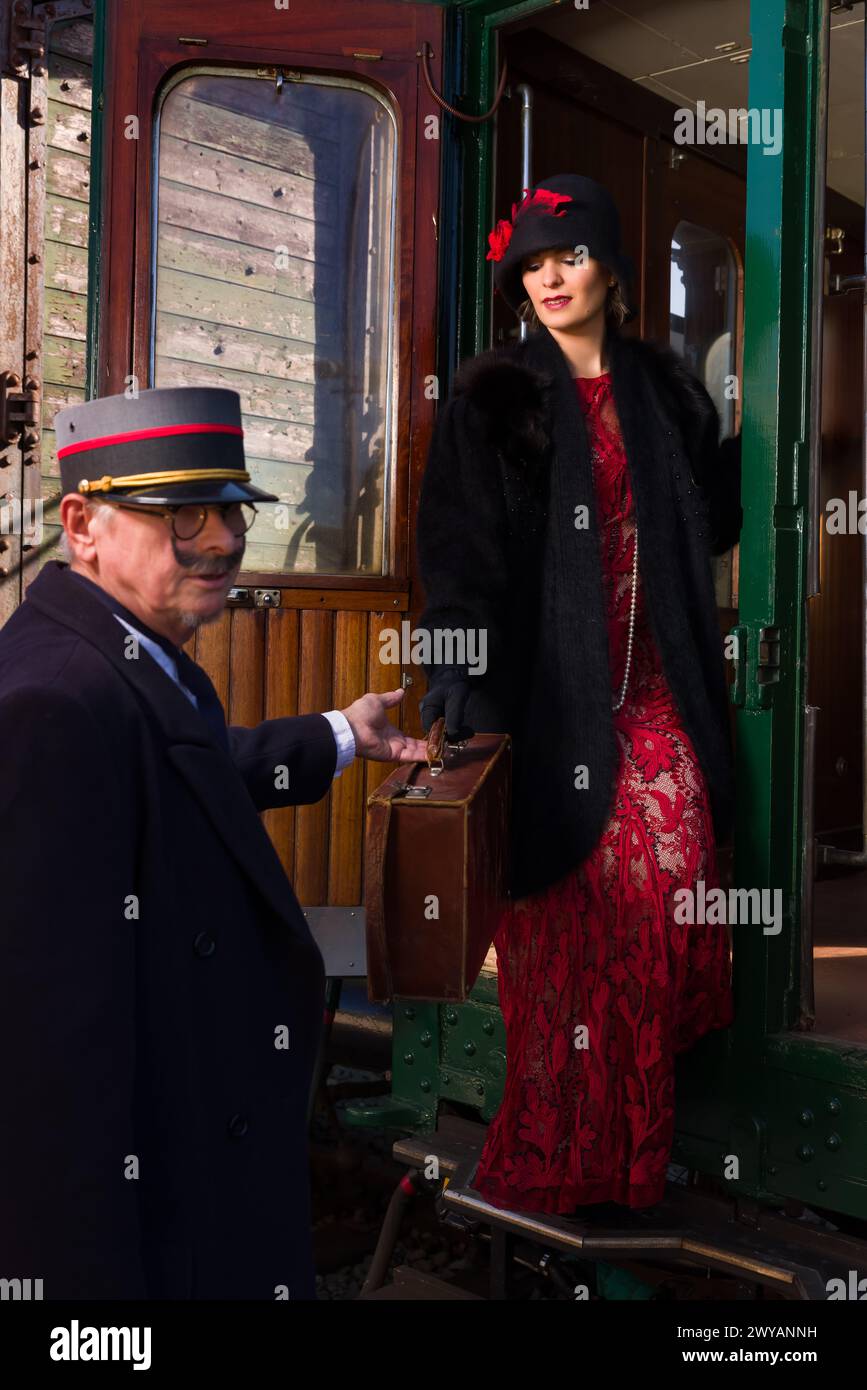 Attractive young woman in red 1920s flapper dress and cloche hat ...