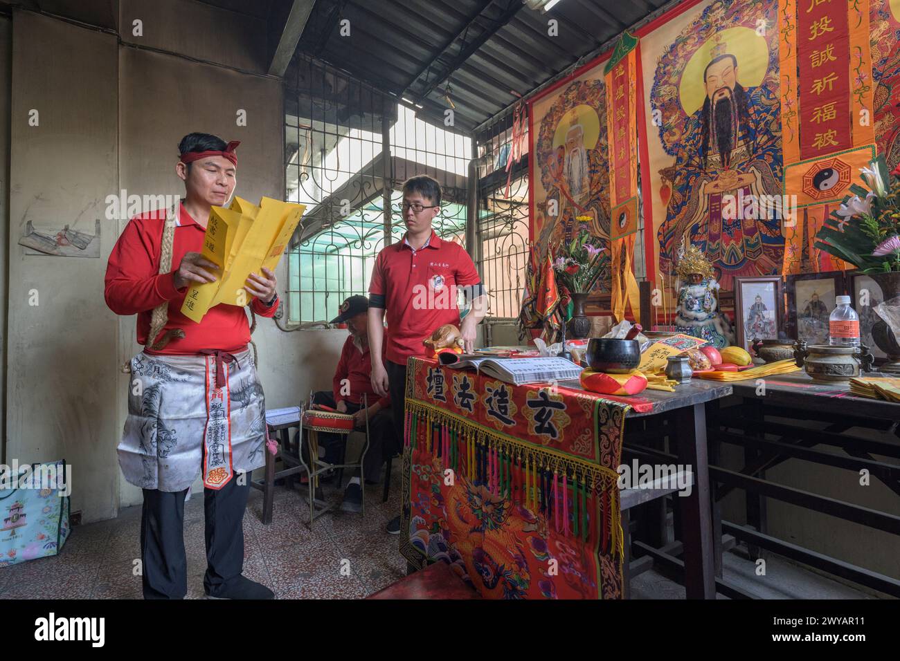 A traditional shaman performing a ritual with offerings to the ...