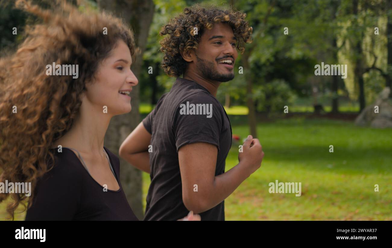 Fitness couple multiracial Caucasian woman and Arabian man running ...