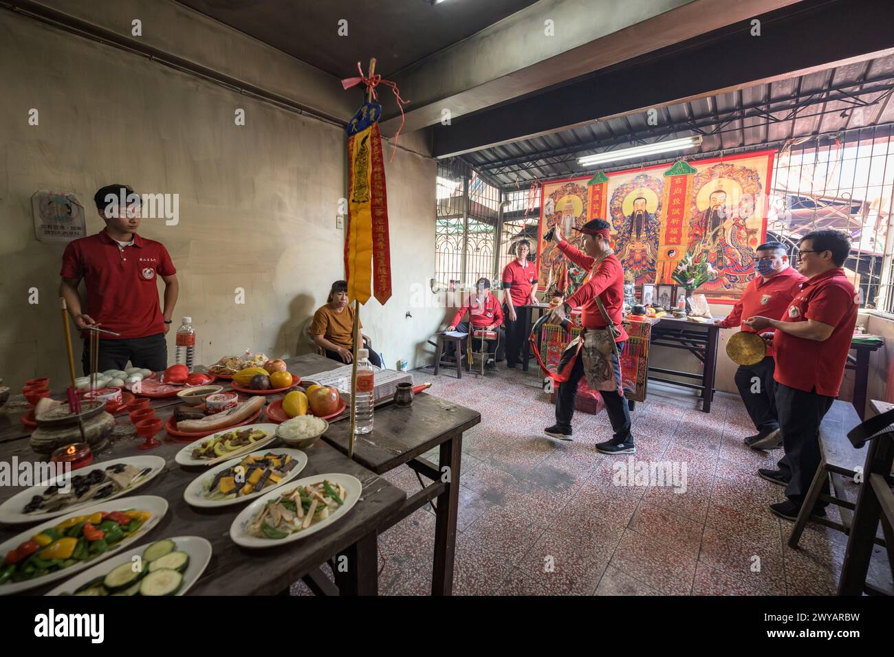 A traditional shaman performing a ritual with offerings to the ...