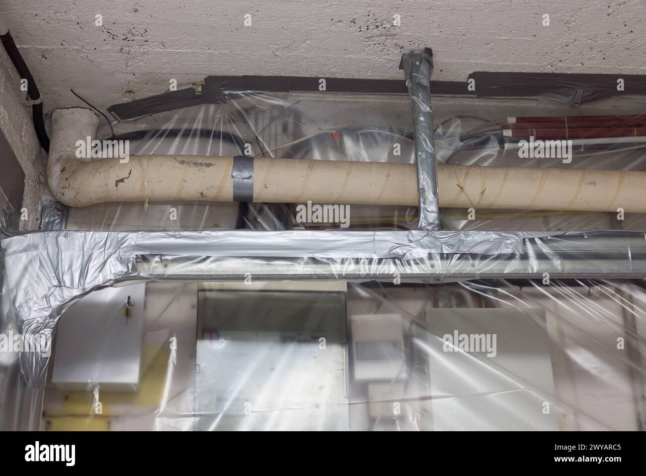 Asbestos removal works off heating pipes insultation going on in a ...