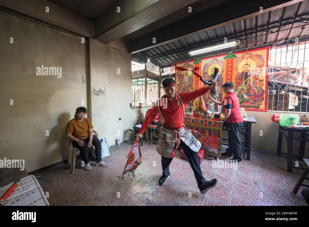 A traditional shaman performing a ritual with offerings to the ...