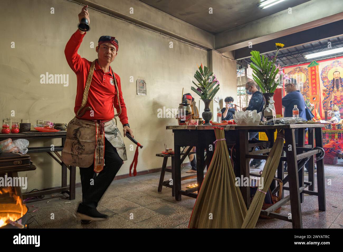 A traditional shaman performing a ritual with offerings to the ...