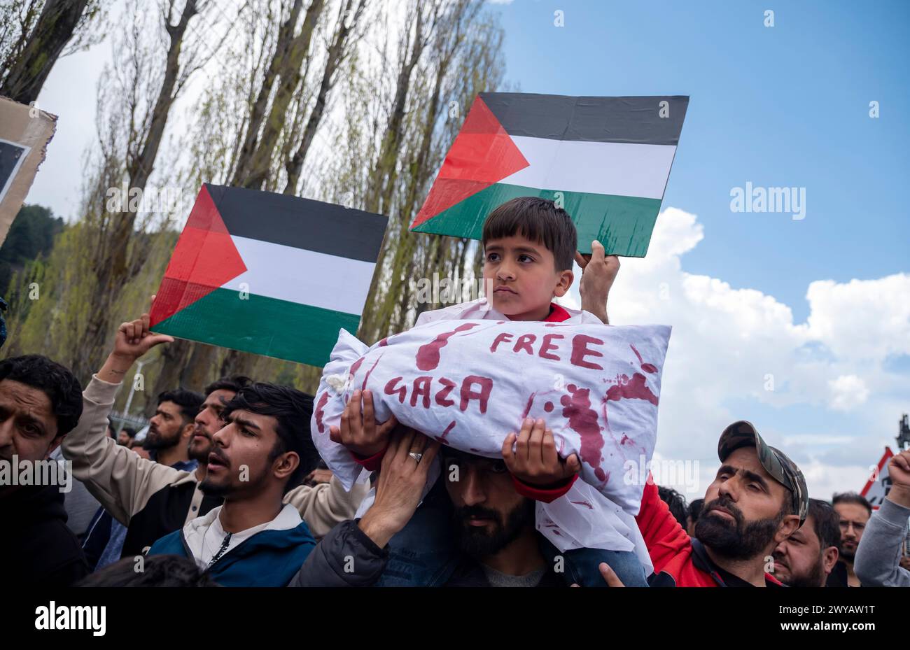 A young kid holds a representation of a shrouded body symbolizing ...