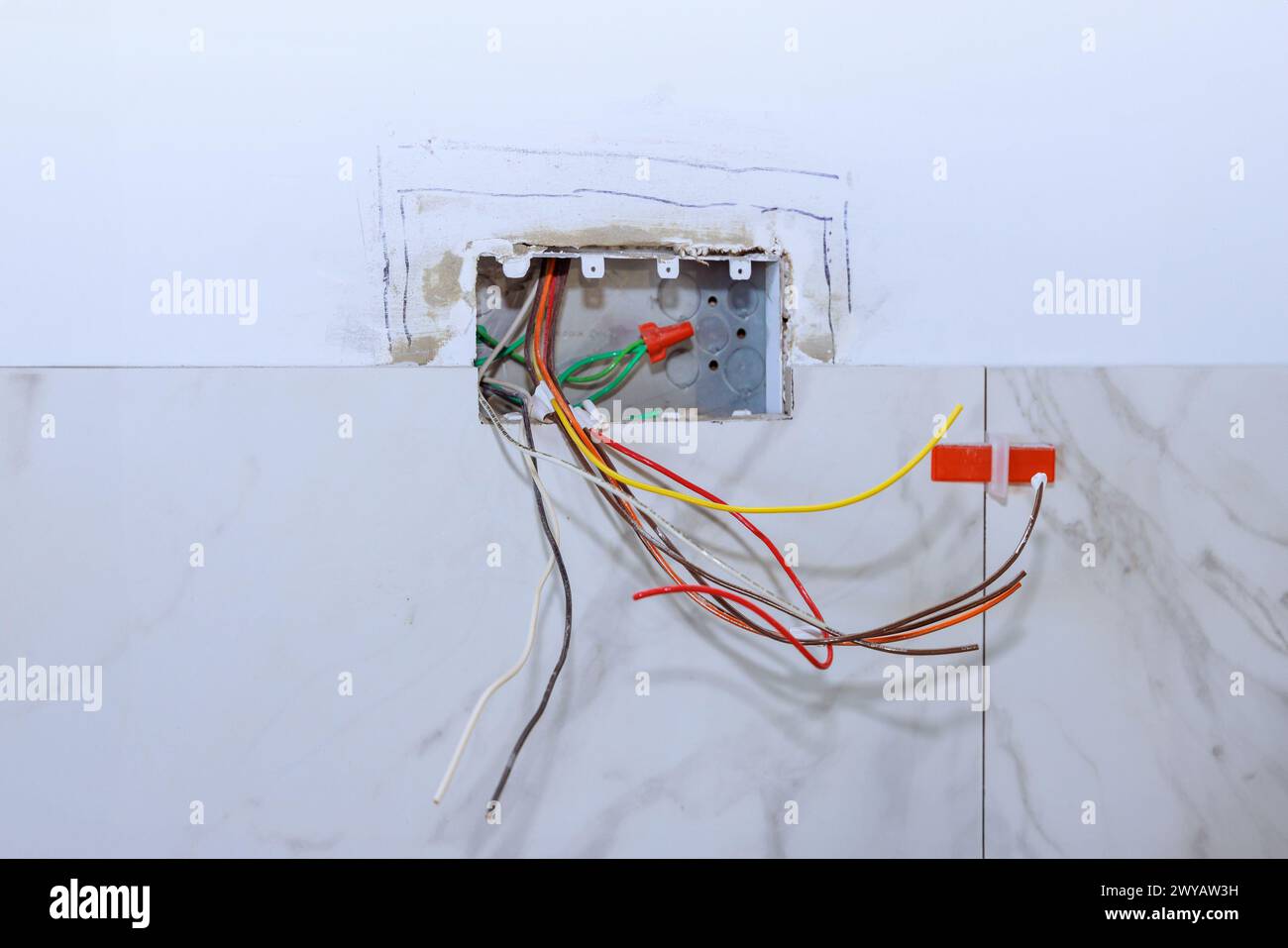 Professional electrician working connection electric socket in wall of ... Professional electrician working connection electric socket in wall of ...
