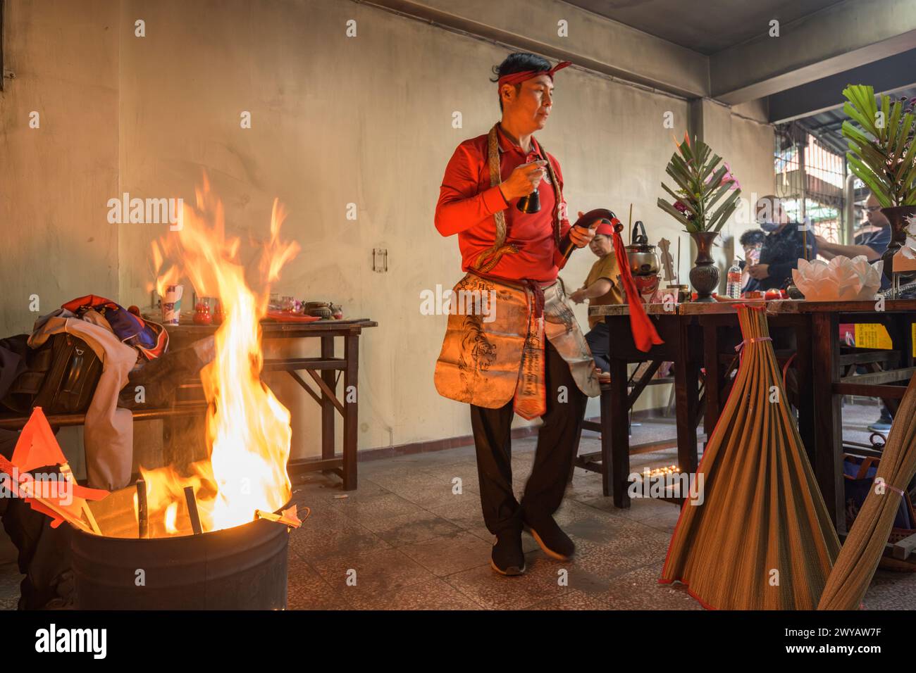 A traditional shaman performing a ritual with offerings to the ...