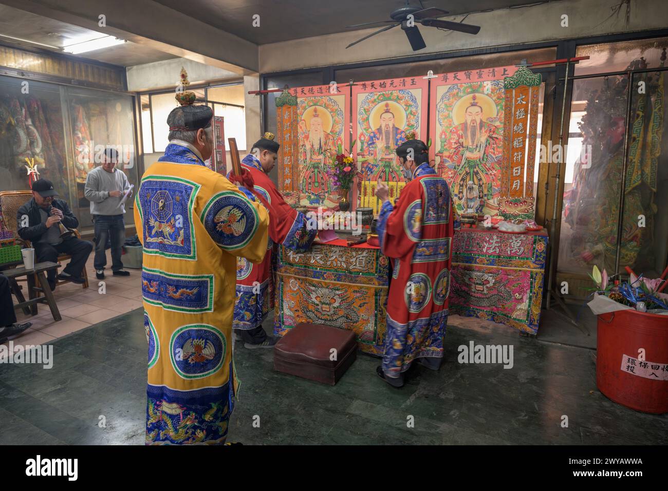 A traditional shaman performing a ritual with offerings to the ...