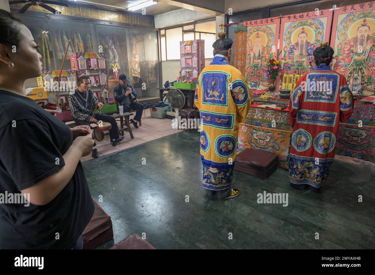 A traditional shaman performing a ritual with offerings to the ...