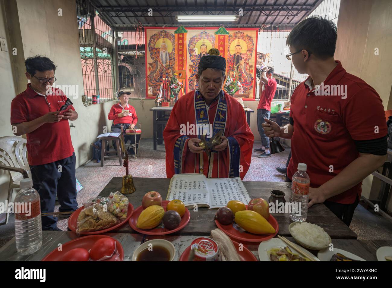 A traditional shaman performing a ritual with offerings to the ...