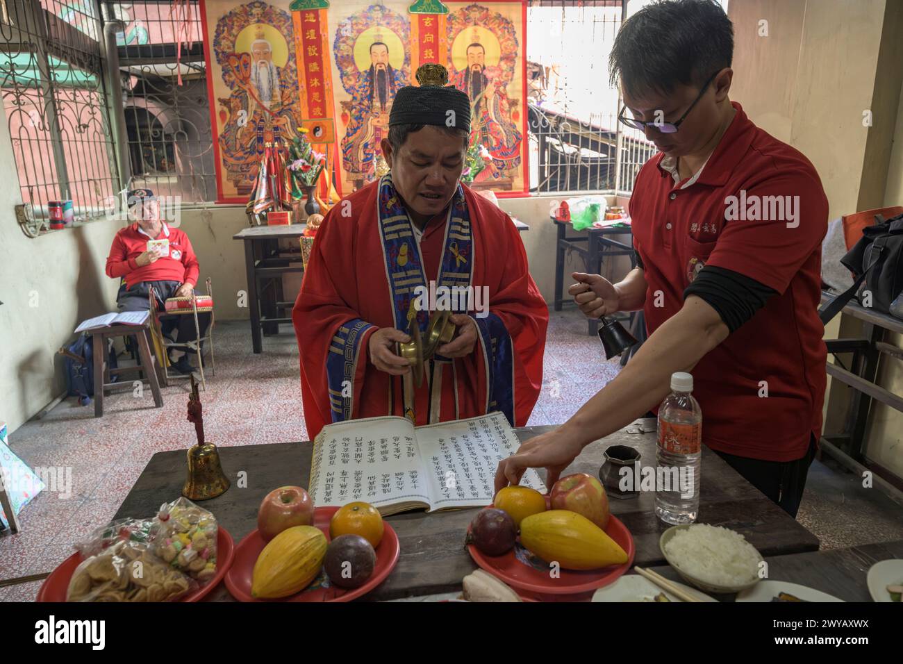 A traditional shaman performing a ritual with offerings to the ...
